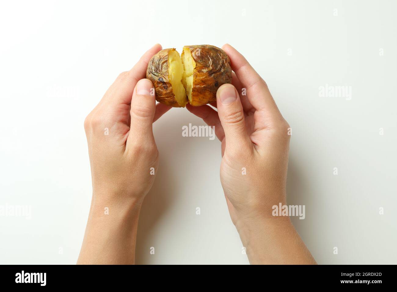 Female hands hold baked potato on white background Stock Photo - Alamy