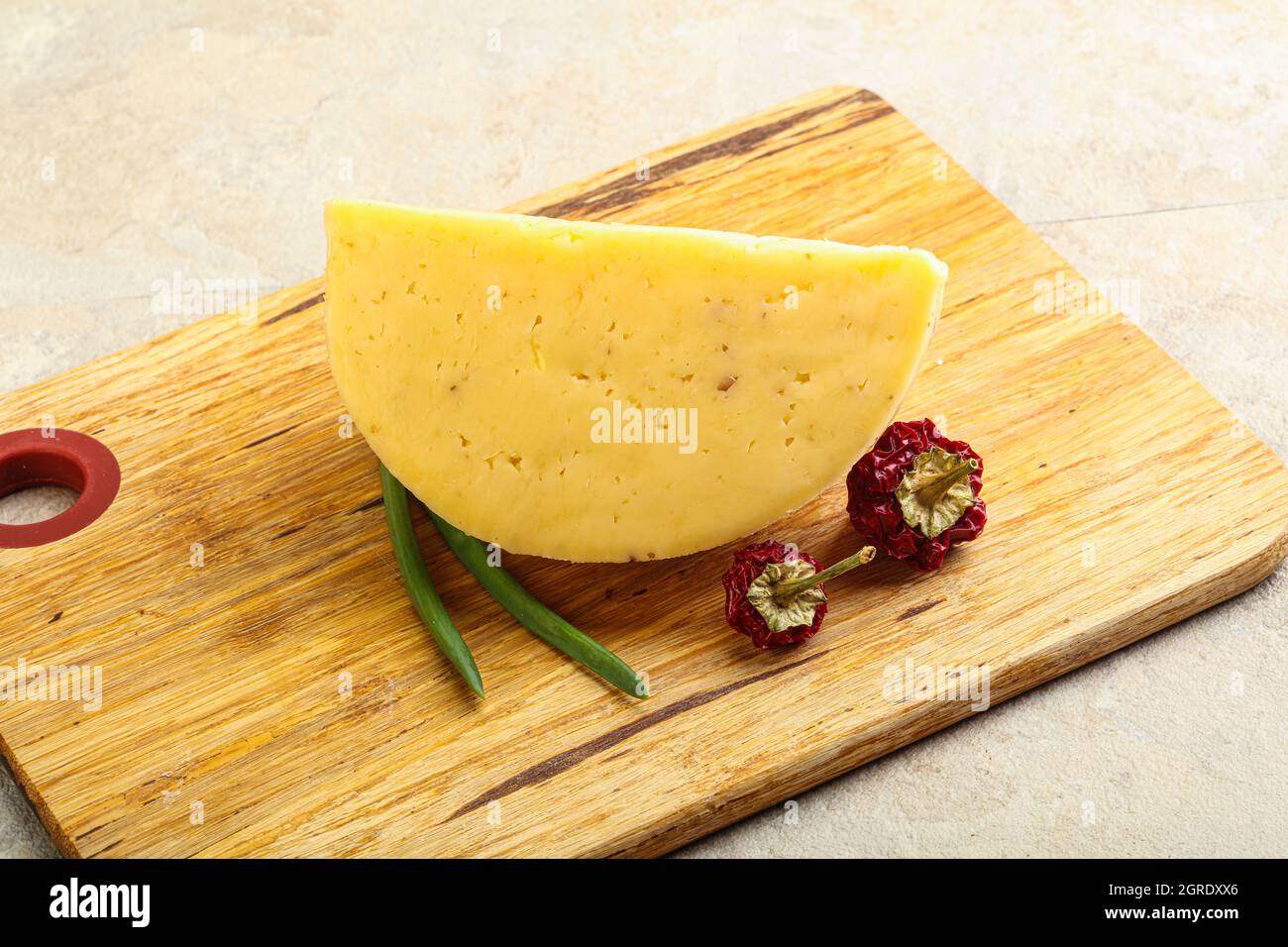 Hard cheese brick with walnut over board Stock Photo - Alamy