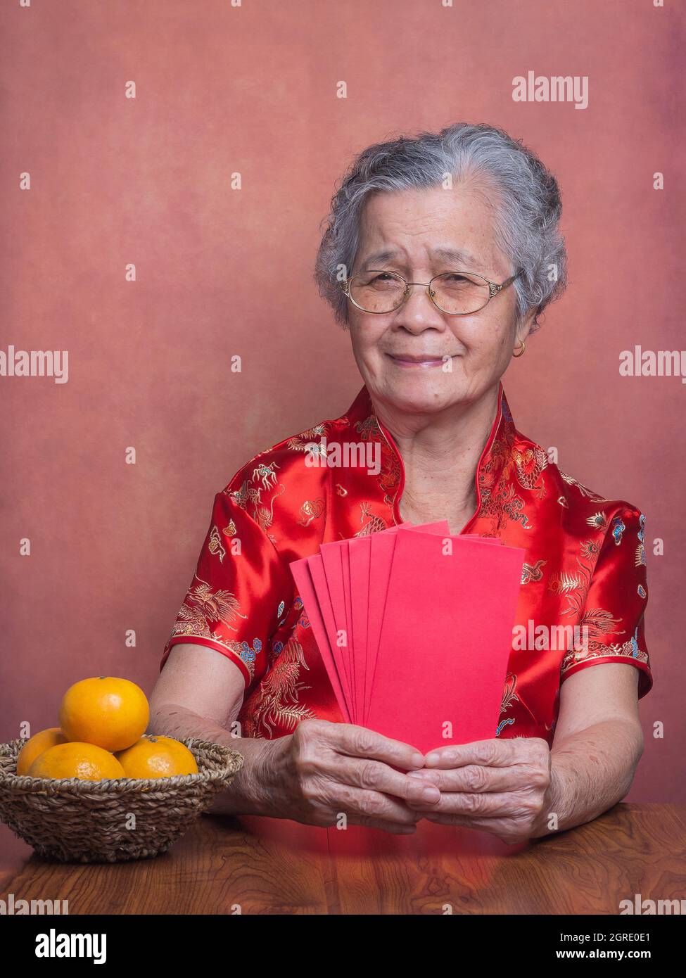 Older woman wearing red dress hi-res stock photography and images - Alamy