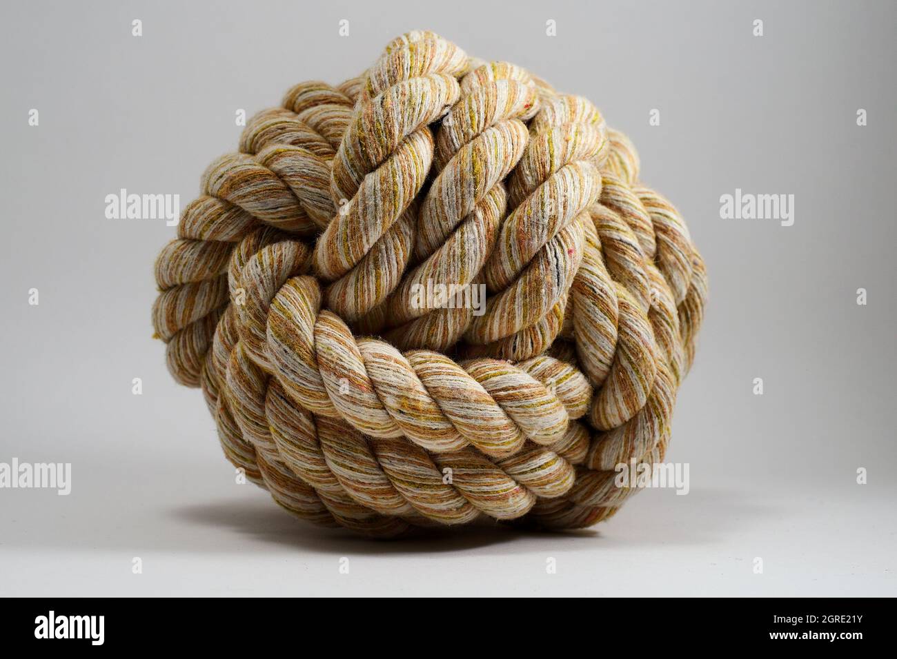 a ball of rope on a neutral background Stock Photo - Alamy