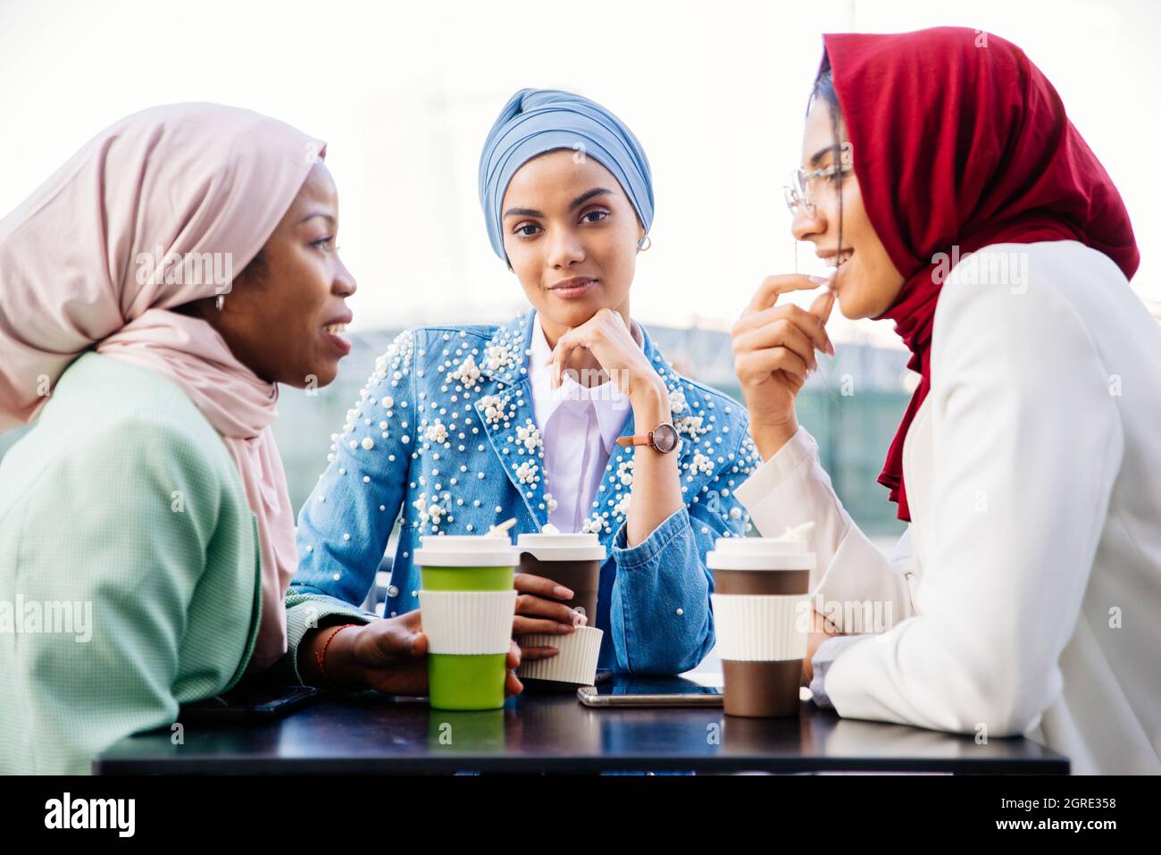 Multiracial Women Sitting At Cafe Stock Photo - Alamy