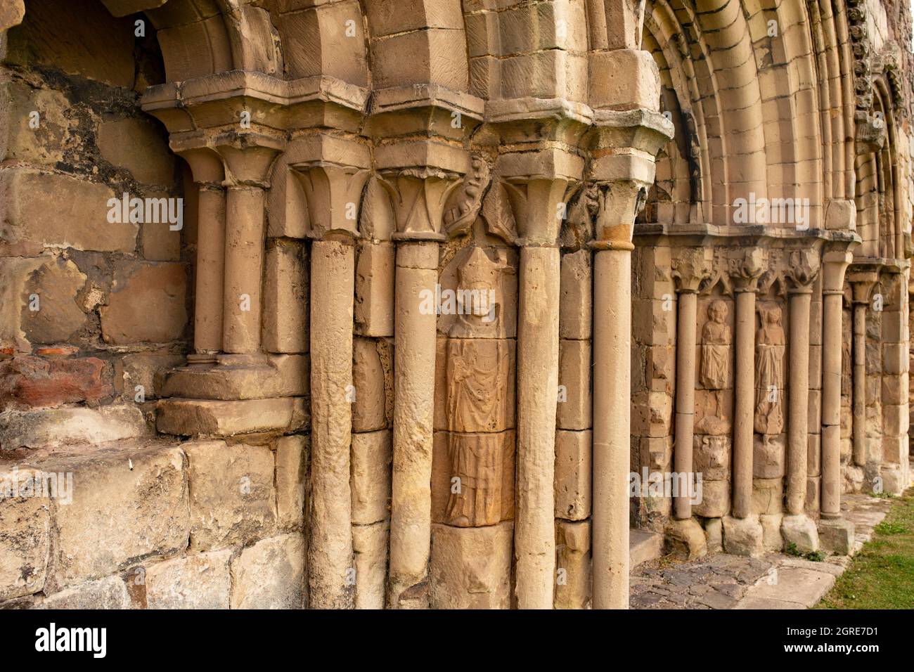 Stone columns and figures carved on a medieval abbey ruin. Medieval ...