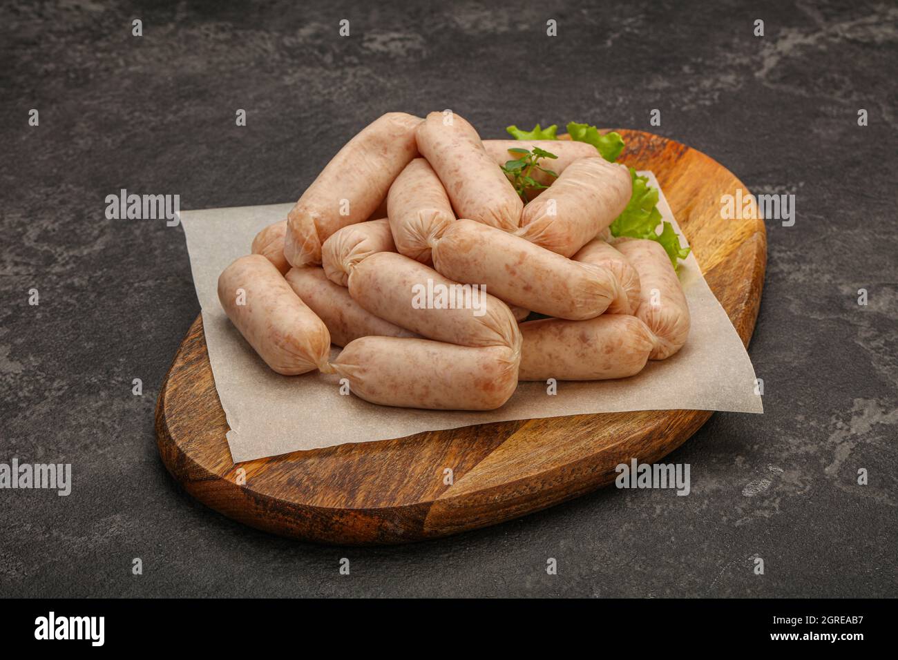 Raw natural chicken baby sausages for roast Stock Photo - Alamy