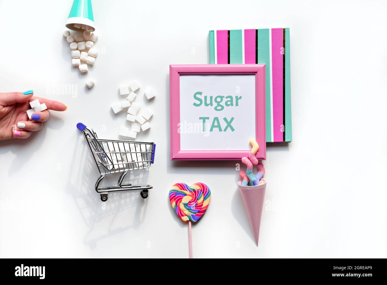 Text Sugar Tax. Various tasty snacks in pastel colors, pink, mint green ...