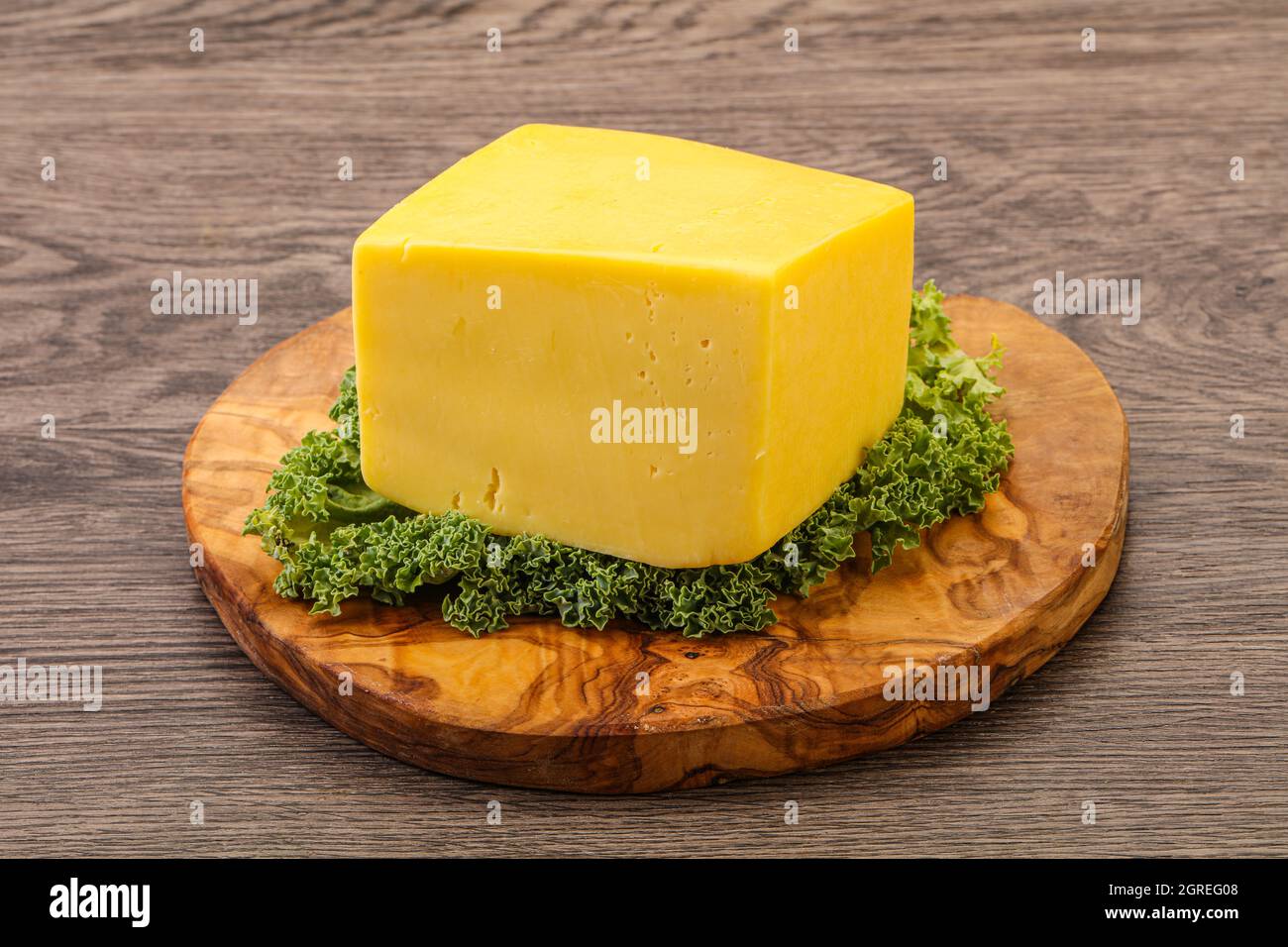 Yellow tilsiter cheese dairy product brick Stock Photo - Alamy
