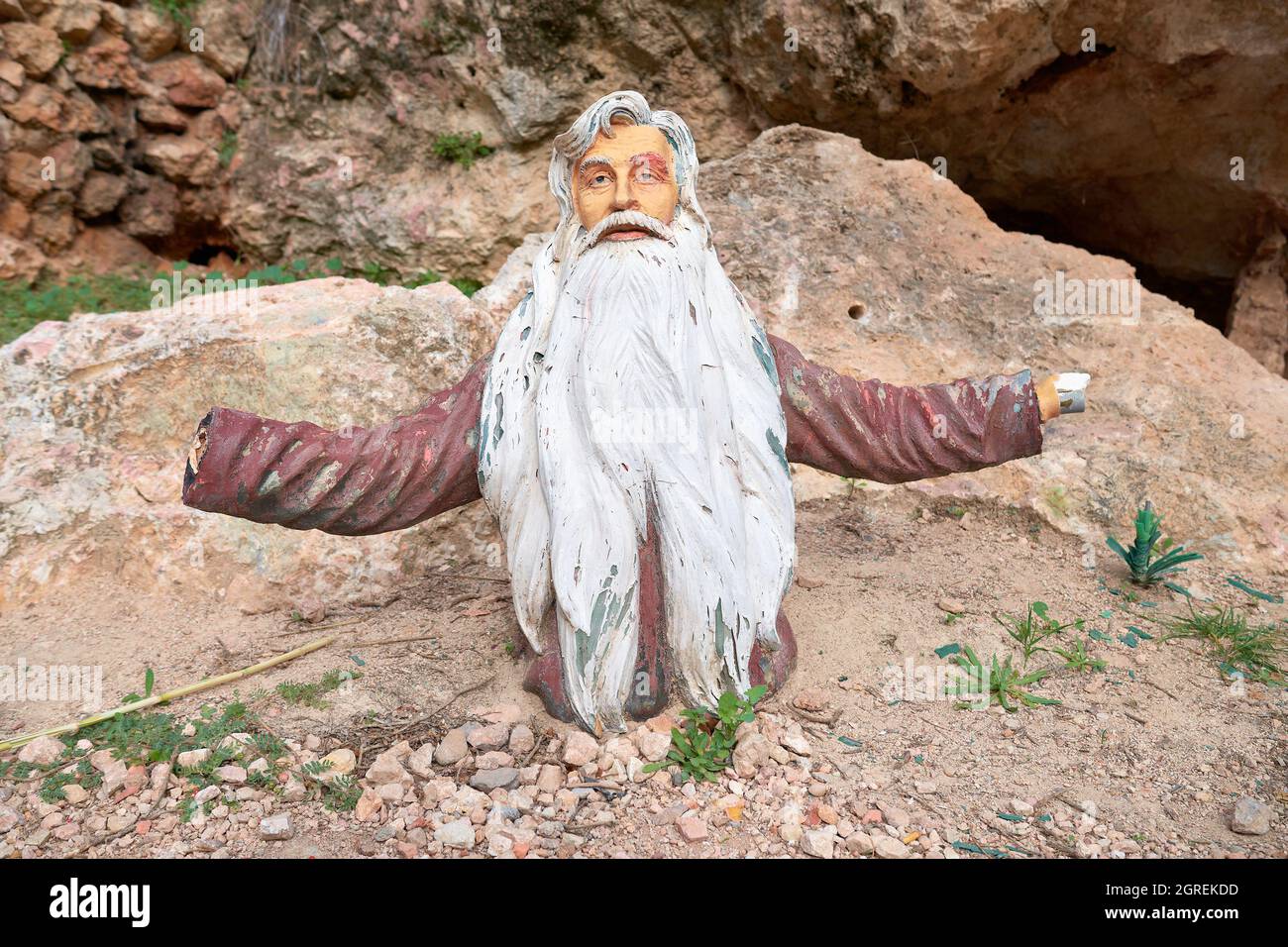 Old statue of an elderly religious man in front of a cave Stock Photo ...