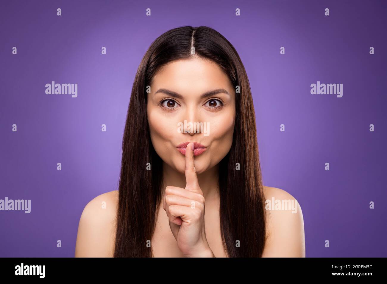 Portrait of attractive mysterious woman showing shh sign isolated over ...