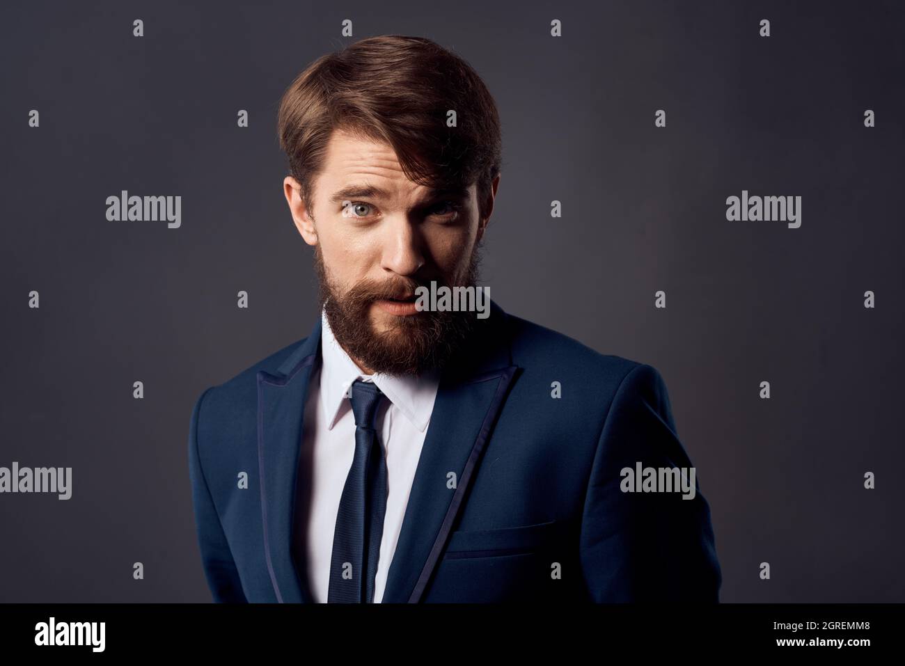 The man in a suit success Job dark background Stock Photo - Alamy