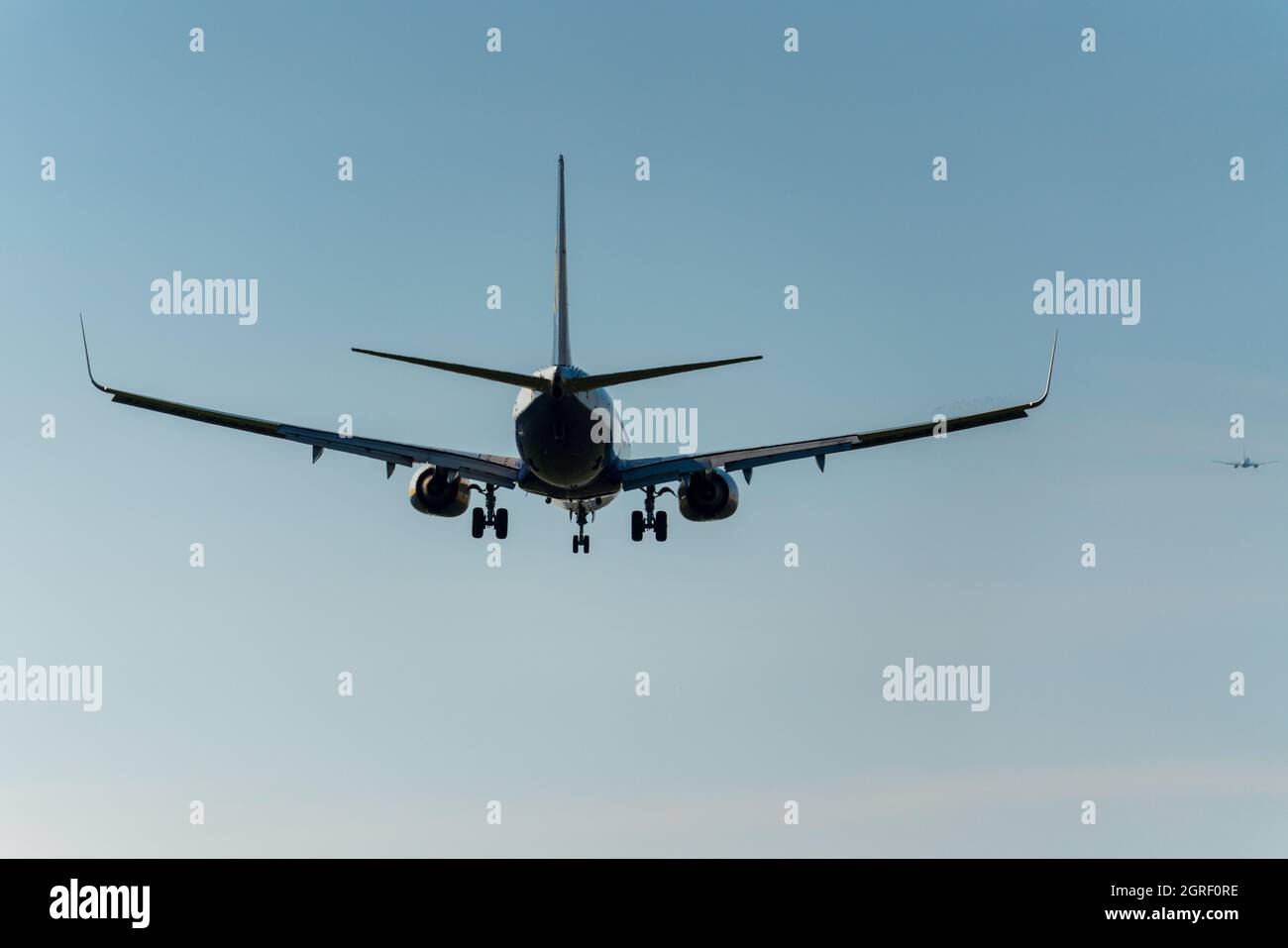 airplane prepares for landing with extended landing gear Stock Photo ...