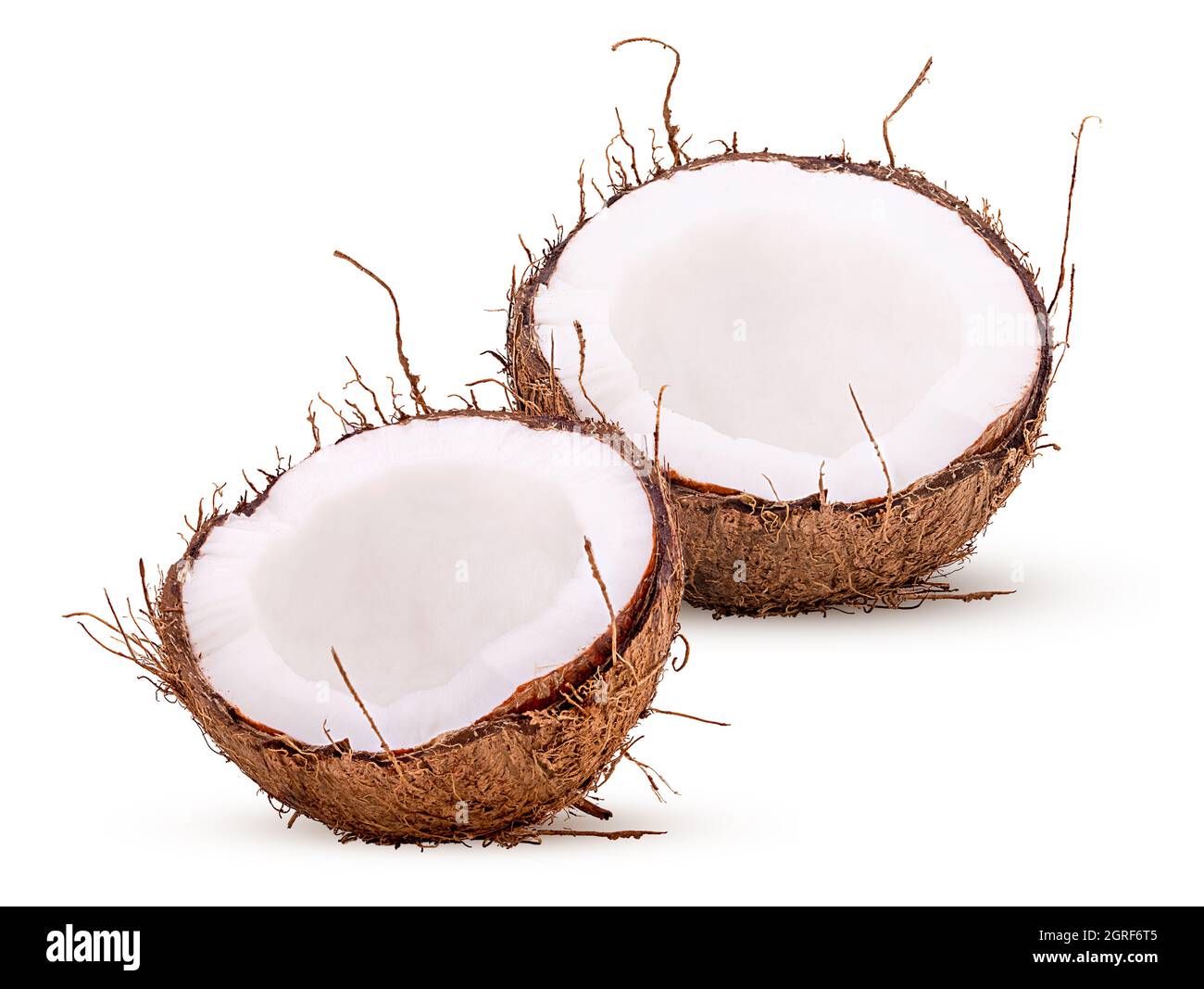 Two freshly coconut in shell cut in half isolated on white background ...