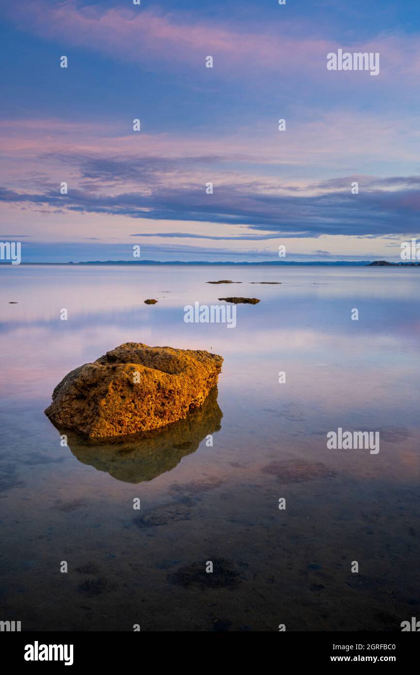 Rock exposed at low tide at dawn at Alau Beach, Alau Beach Campground ...