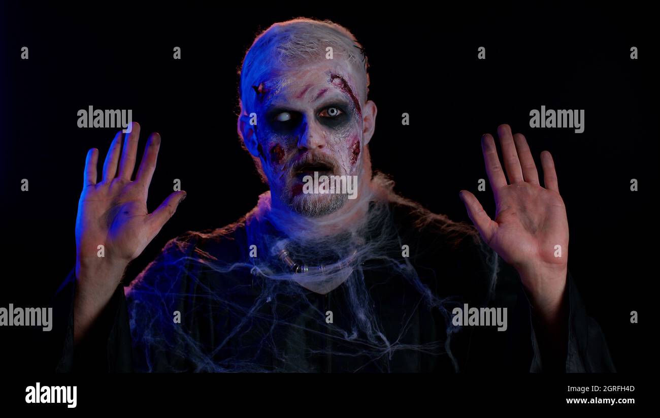 Sinister man Halloween crazy zombie with bloody wounded scars face ...