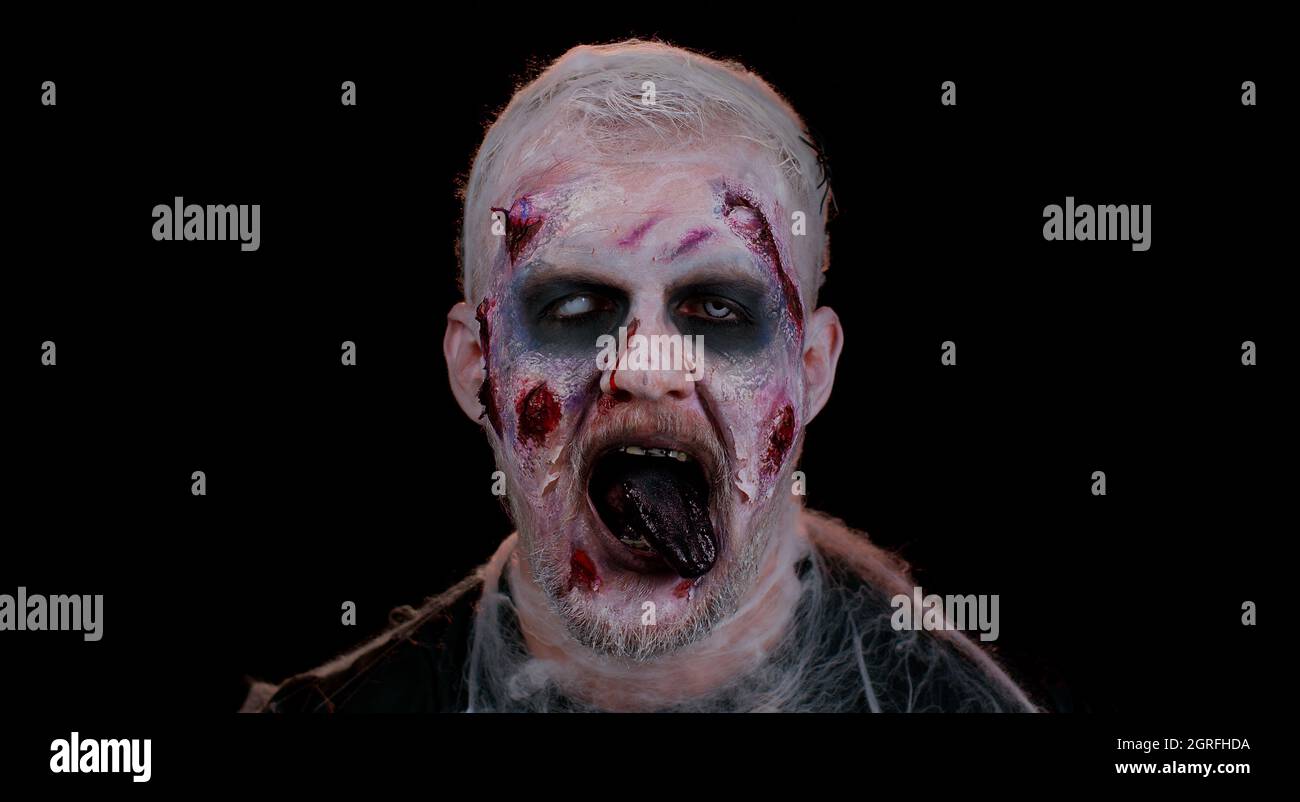 Frightening scary man with Halloween zombie bloody wounded makeup ...