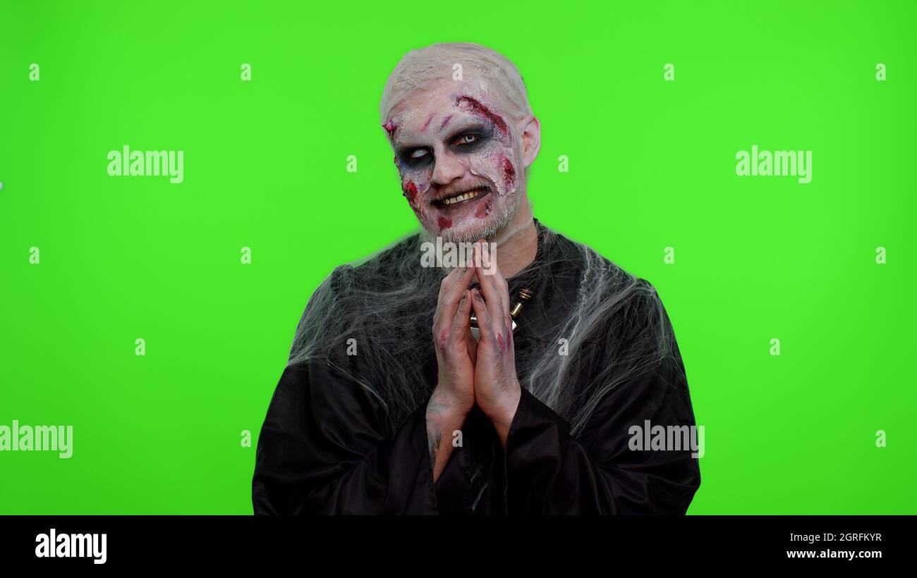 Sneaky cunning zombie Halloween man scheming evil plan, thinking over ...