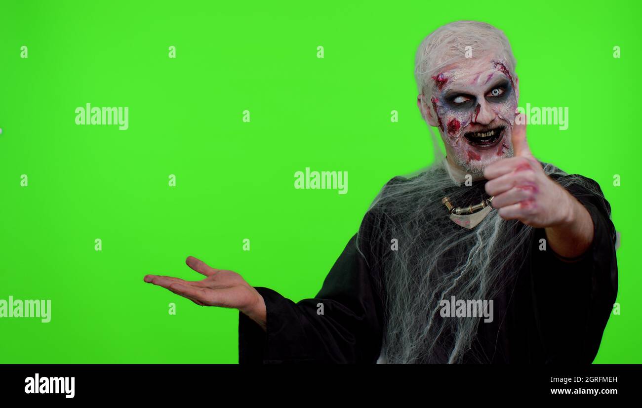 Scary wounded Halloween zombie undead man showing thumbs up and ...