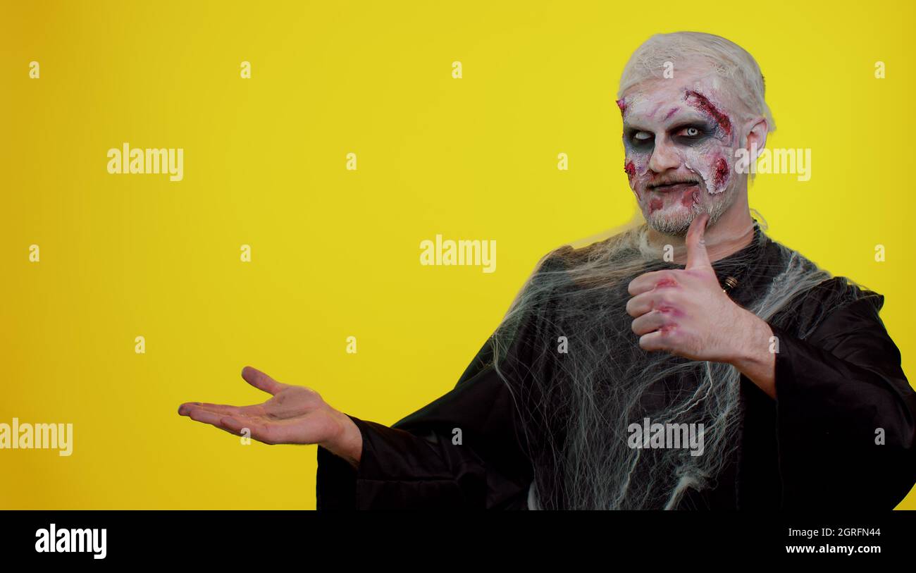 Halloween zombie showing thumbs up, pointing empty place advertising ...