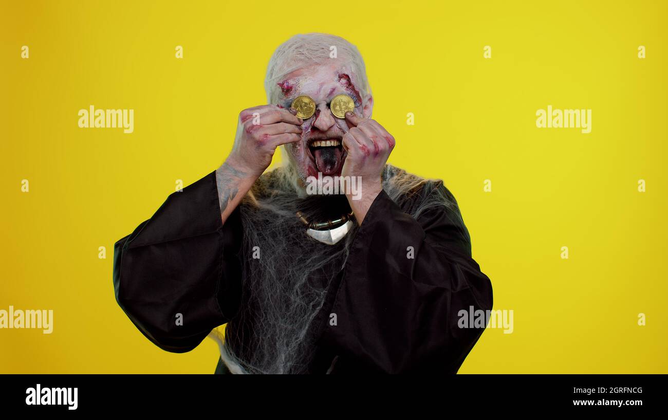 Spooky man with bloody scars face, Halloween zombie showing golden ...