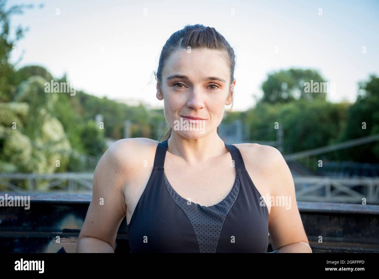 portrait caucasian young brunette athlete woman posing and smiling ...