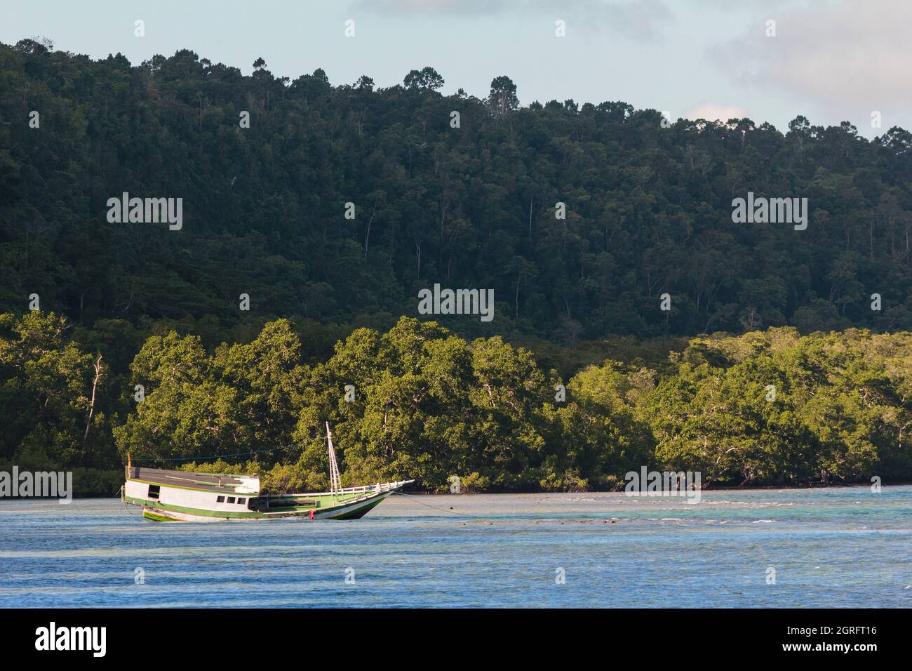 Indonesia, Papua, Biak island, Bosnik beach, fishing boat beached in ... Indonesia, Papua, Biak island, Bosnik beach, fishing boat beached in ...