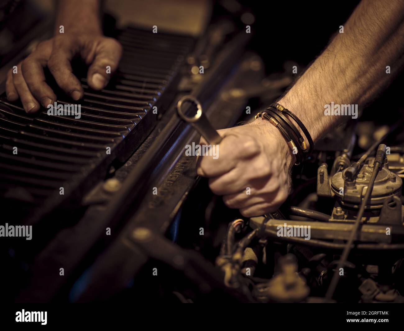 View of a man's strong hands with leather bracelets fixing the gear of ...