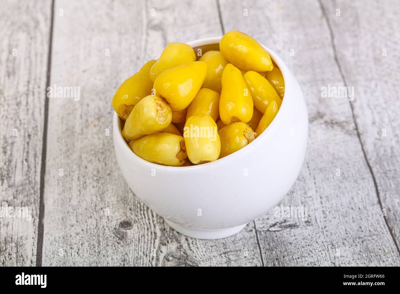 Pickled Yellow spicy mini pepper in the bowl Stock Photo - Alamy