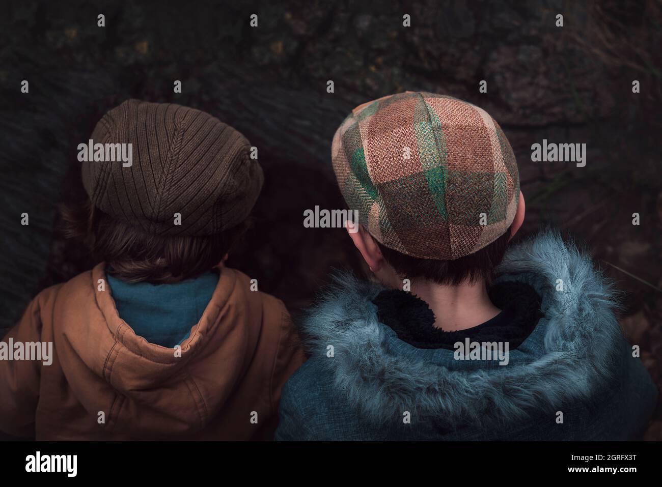 Closeup of two boys in autumn outfits. Back view Stock Photo - Alamy