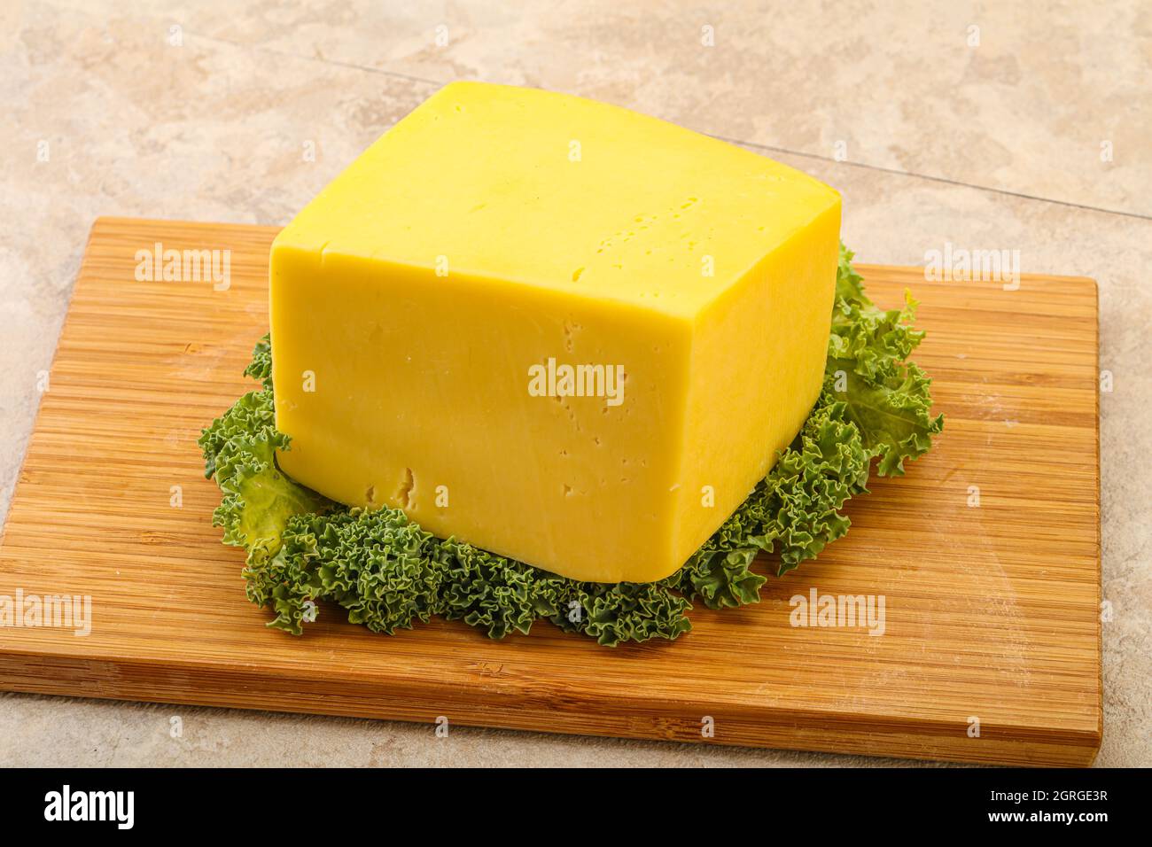 Yellow tilsiter cheese dairy product brick Stock Photo - Alamy