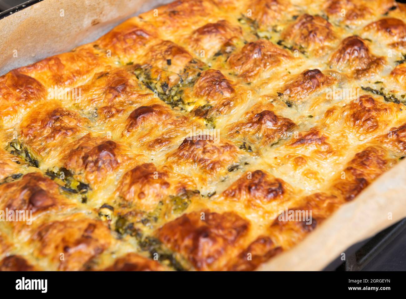 Delicious homemade cheese puff pastry on e tray. Rectangle slices on a ...