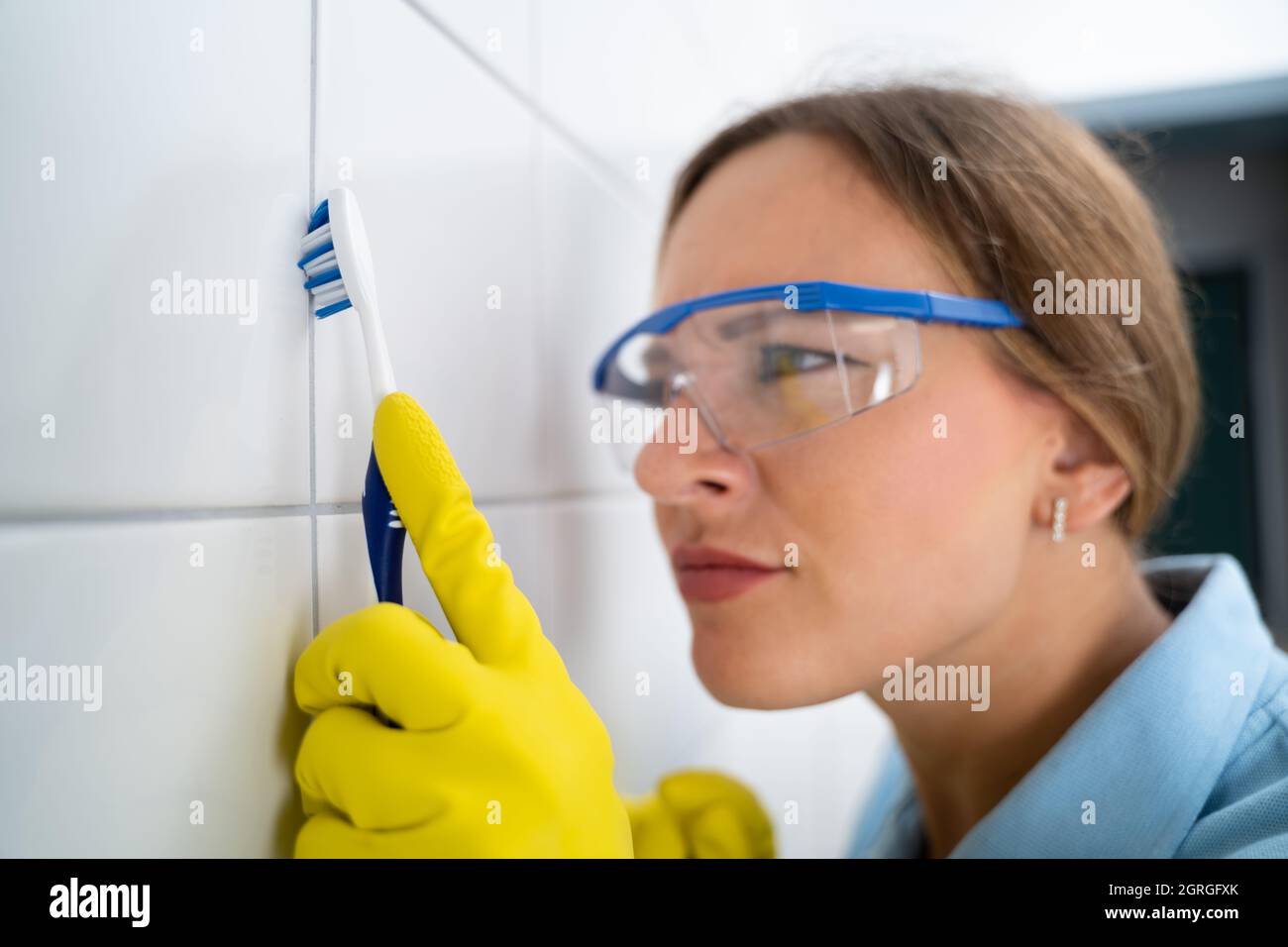 Cleaning Dirty Tile Grout In Bathroom Using Toothbrush Stock Photo - Alamy