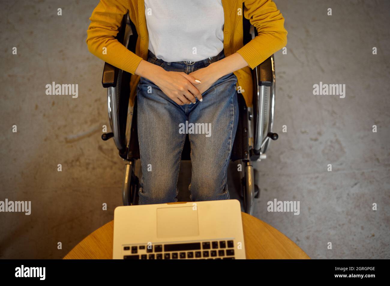 Disabled female student in wheelchair using laptop Stock Photo - Alamy
