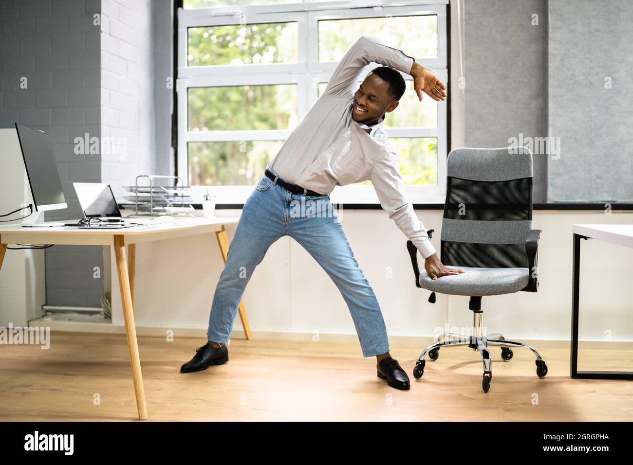 African American Male Exercise Office. Stretching Workout Stock Photo ...