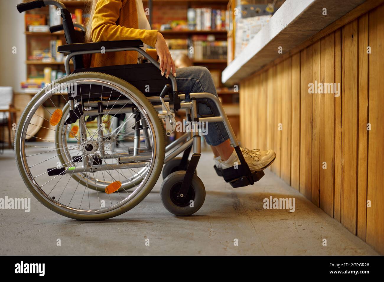 Disabled female student in wheelchair at counter Stock Photo - Alamy