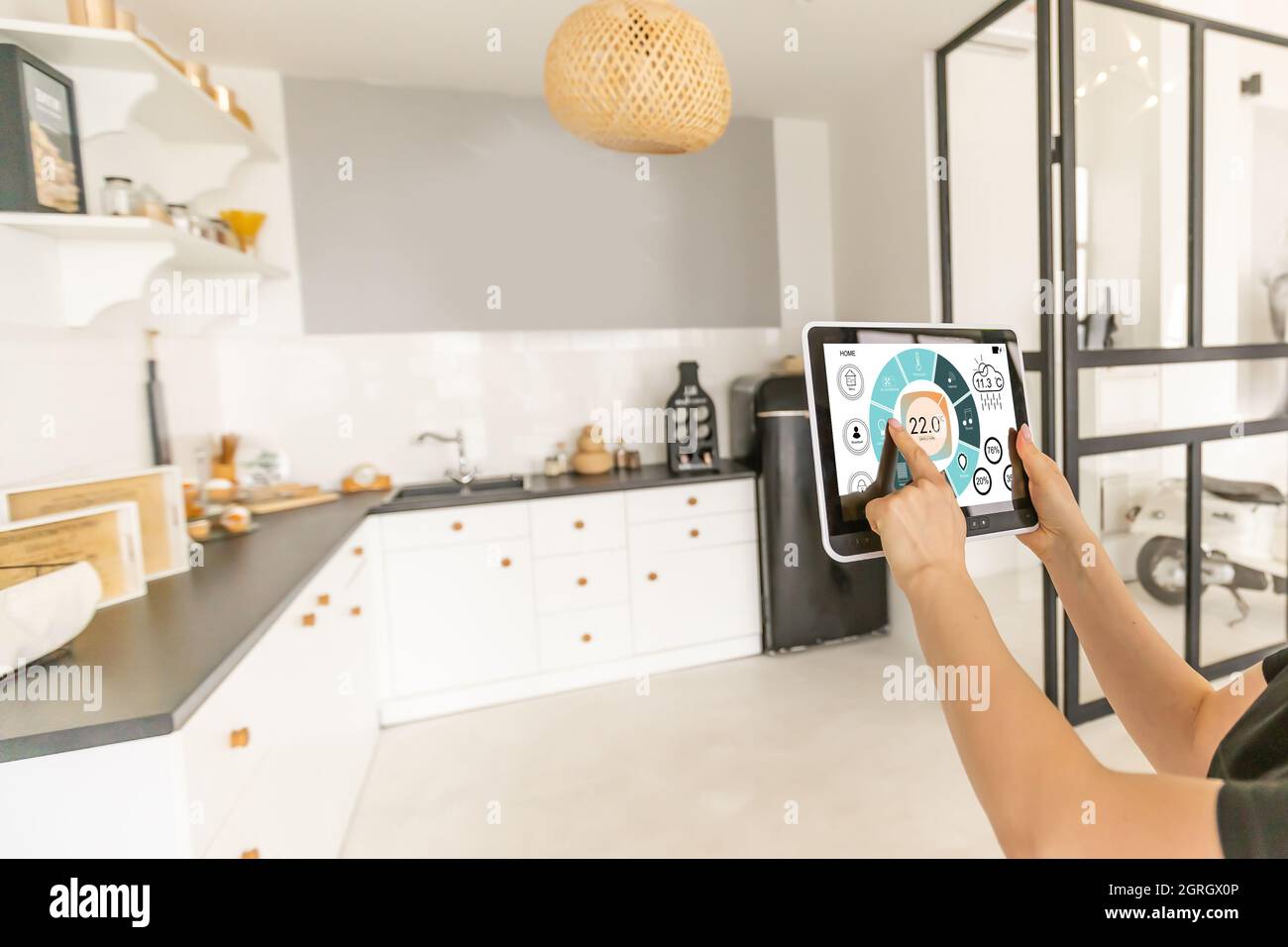 Female hands hold a tablet computer with system clever house on a ...
