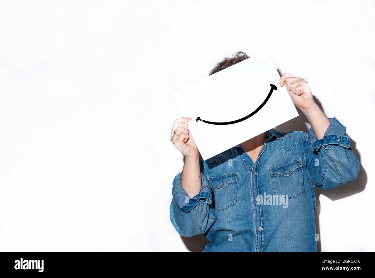 Person holding a paper with cool emoticon face. Copy space Stock Photo ...