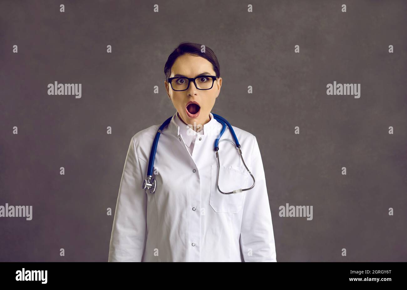 Studio portrait of funny shocked nurse or doctor with open mouth ...