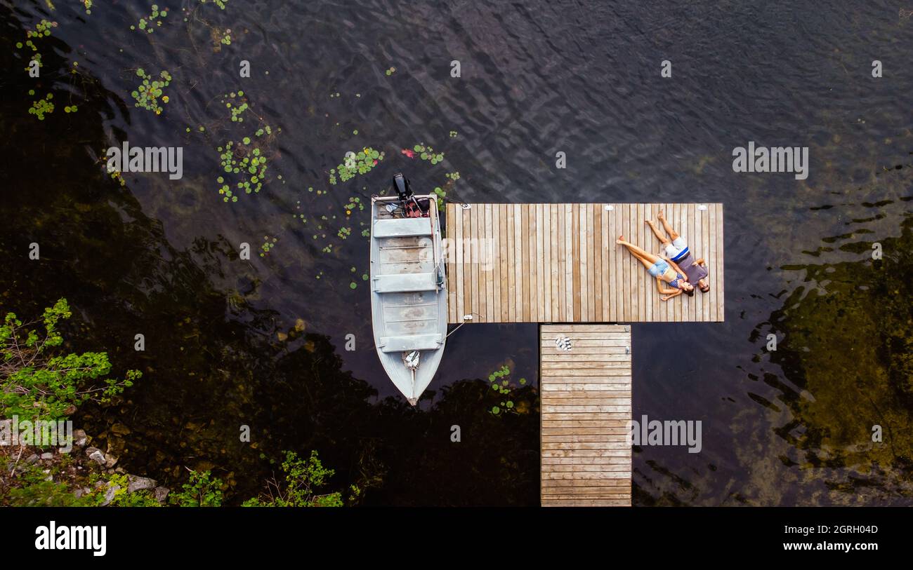 Overhead aerial image of couple laying on a dock together Stock Photo ...