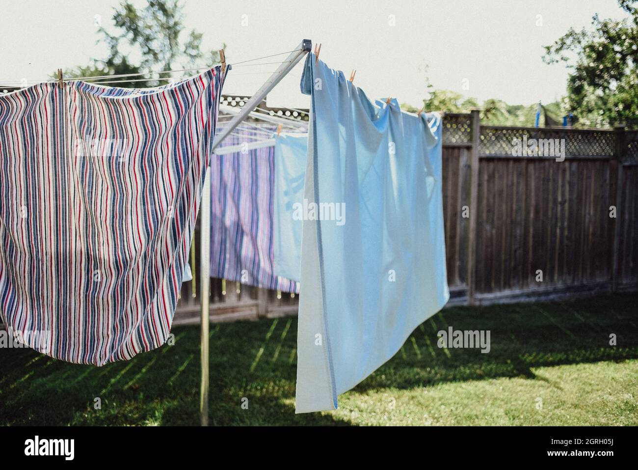 Sheets hanging on a clothesline in a backyard on a summer day Stock ...
