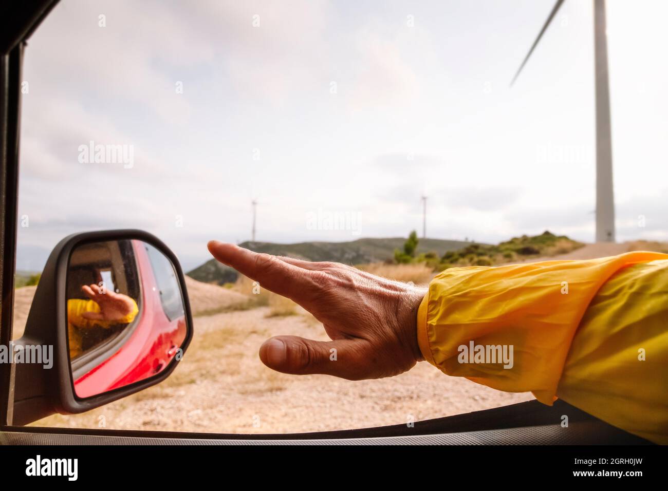 A man travels by car with his hand out the window and catches the wind ...
