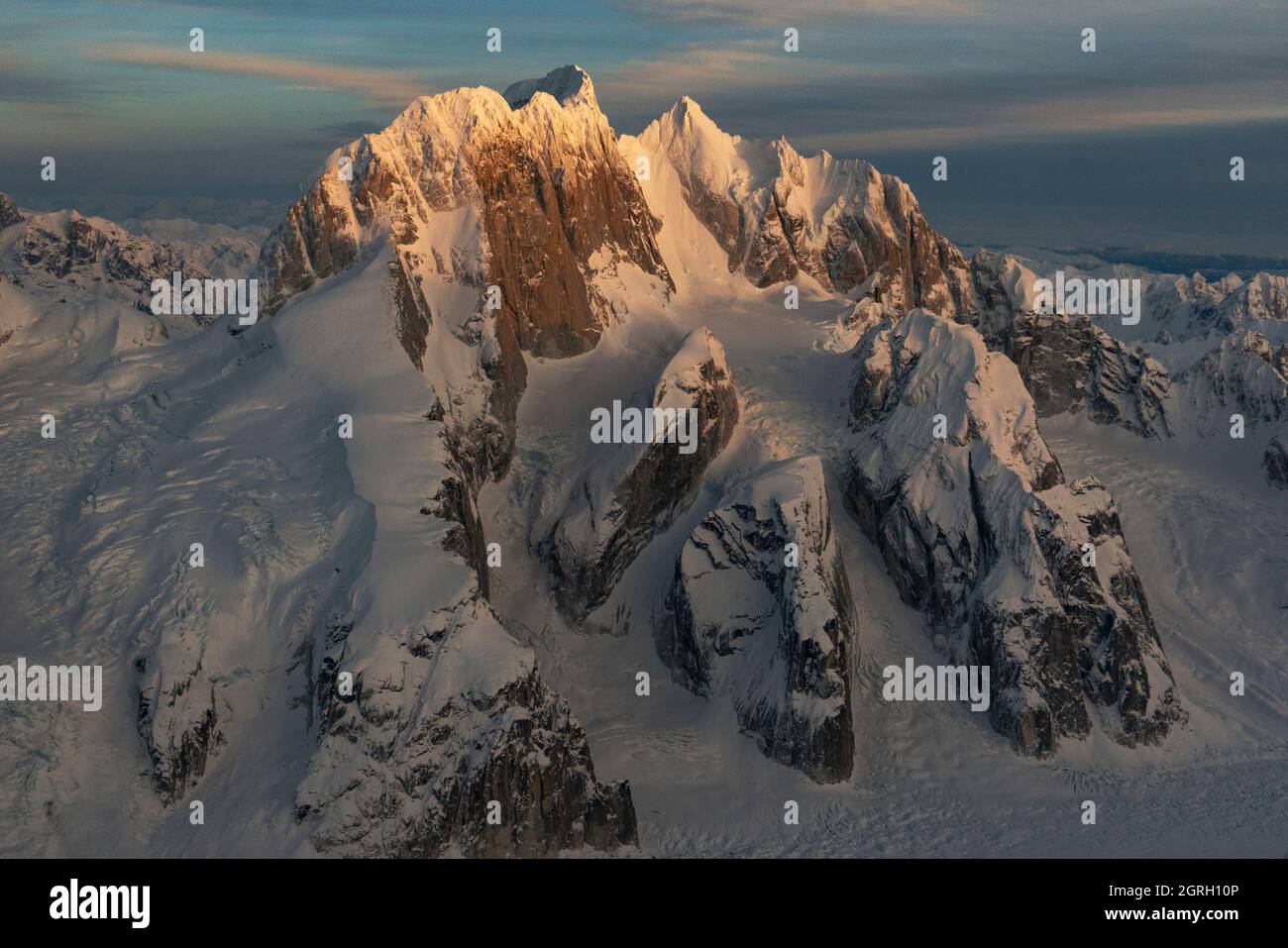 Sunset shines on snow covered peaks of Moose's tooth, a popular ...