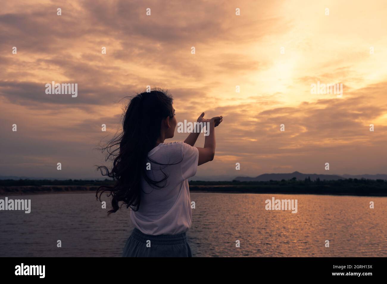Woman alone standing prayer hands hi-res stock photography and images ...
