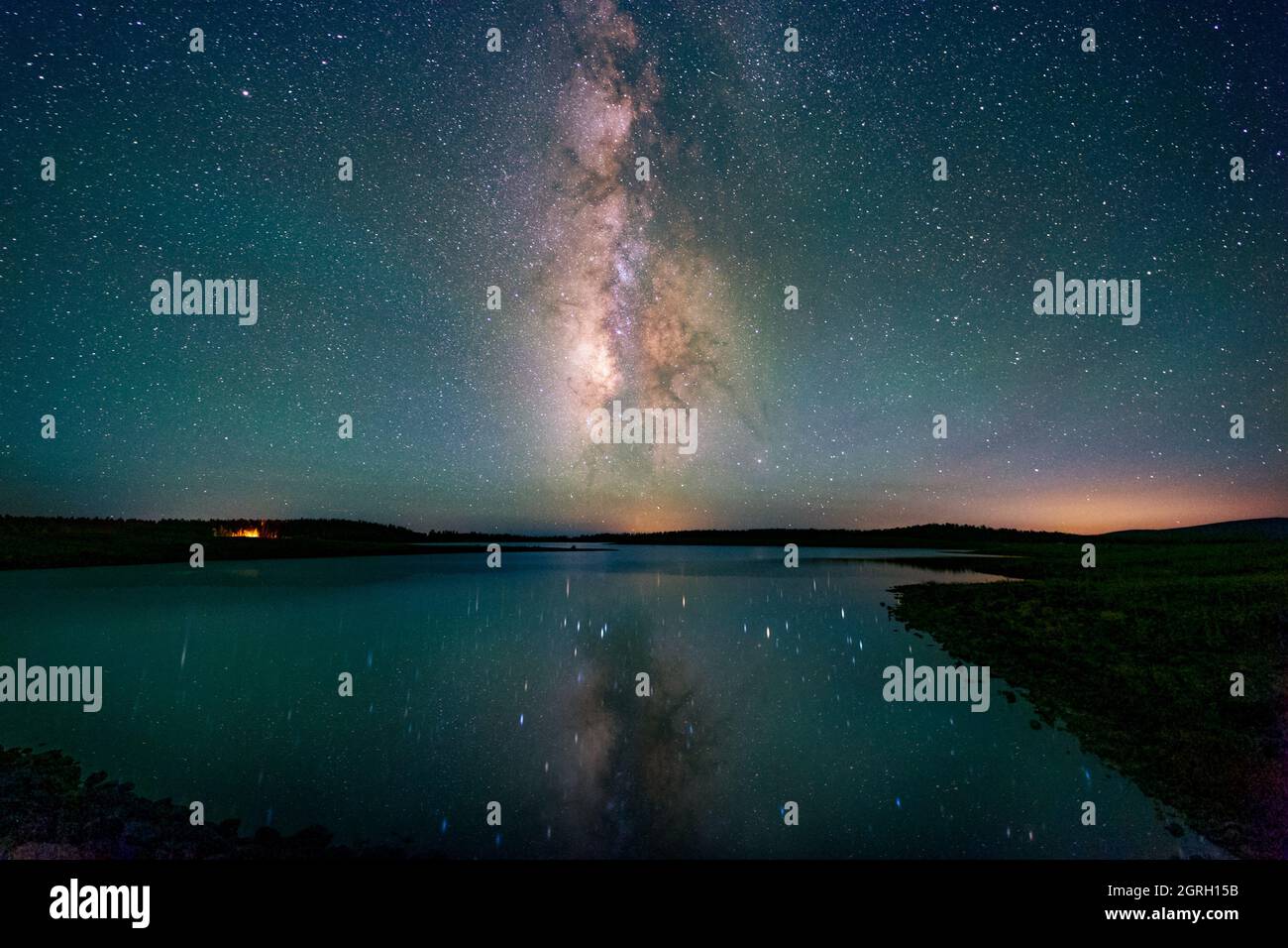 Beautiful starry night sky above a lake and landscape Stock Photo - Alamy