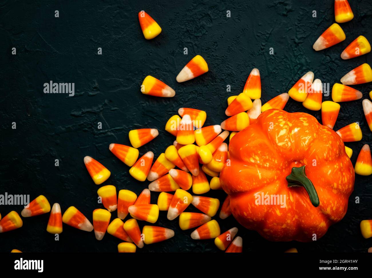 Halloween pumpkin and candy corn banner on blue baclground. Top view ...