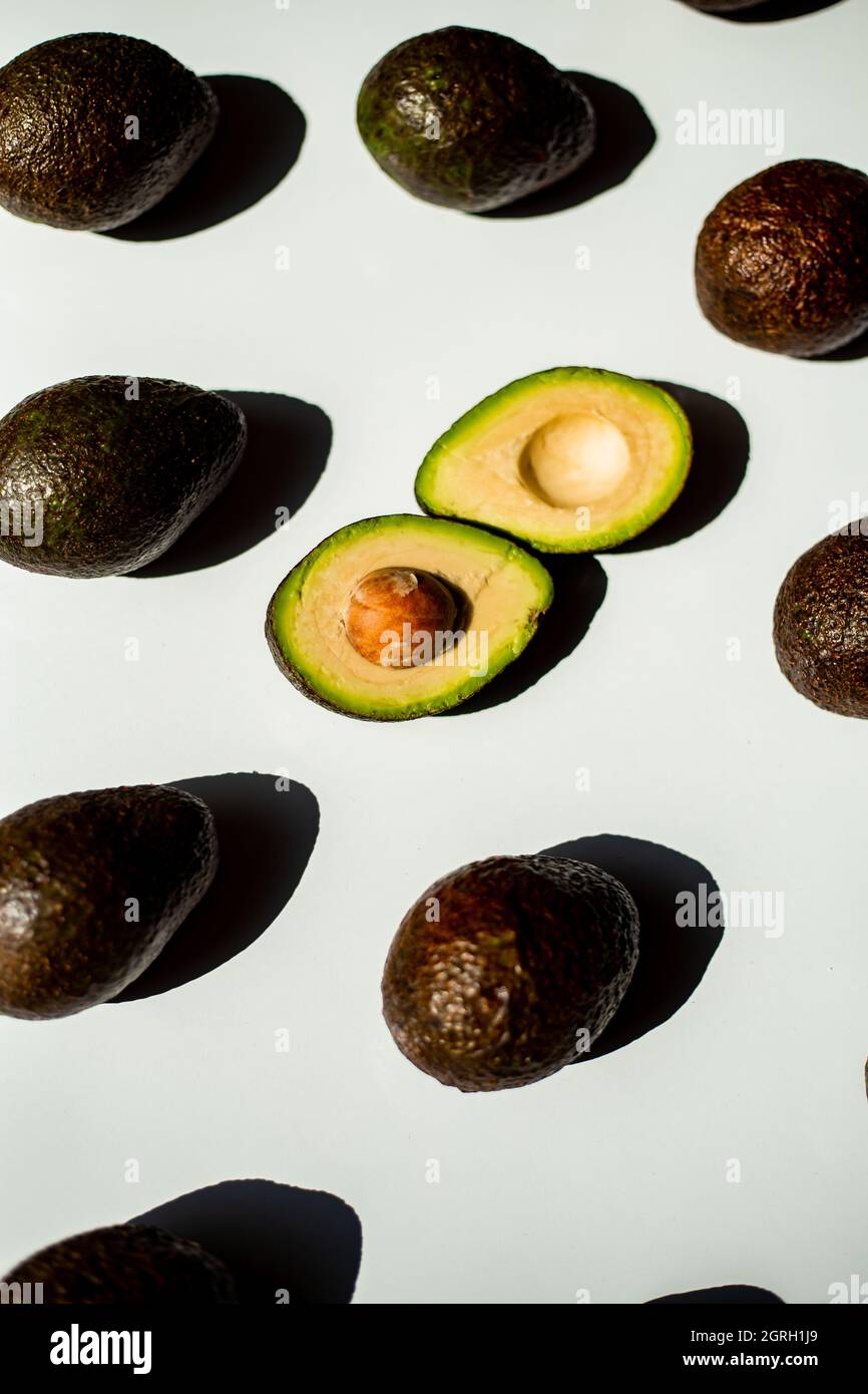 Many avocados on white background Stock Photo - Alamy