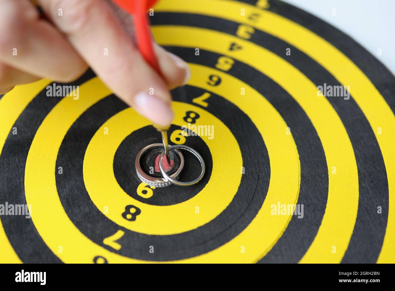 Female hand holds dart and rings in center of dart board Stock Photo ...