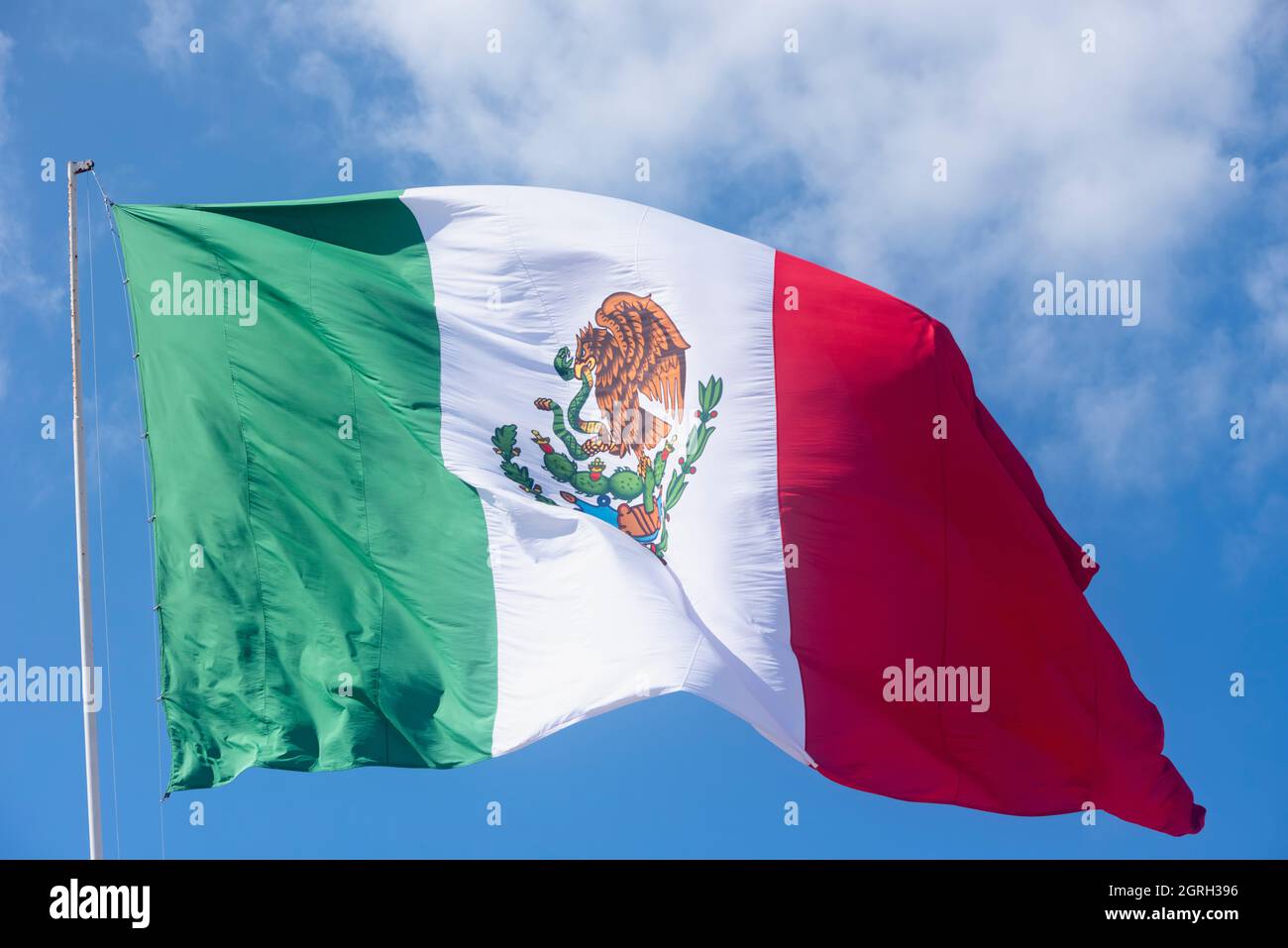 The National flag of Mexico against the blue sky, Playa del Carmen ...