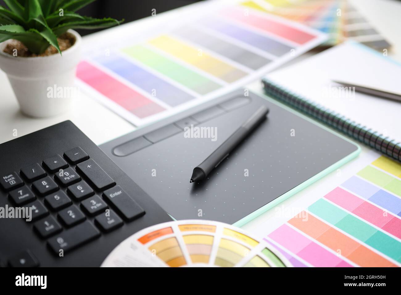 Graphic tablet stylus and color palette on table Stock Photo - Alamy
