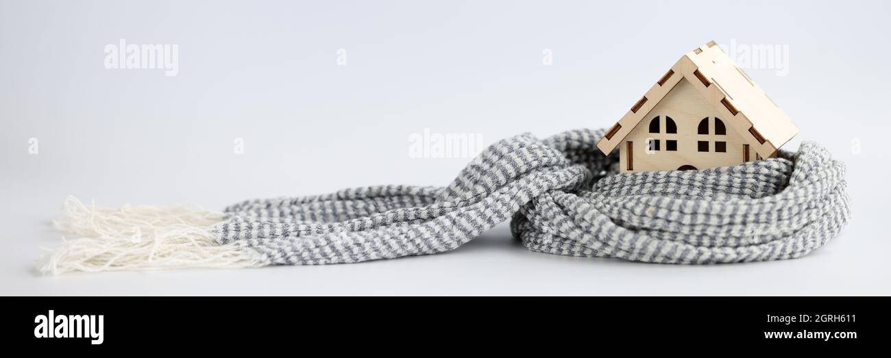 Small wooden house wrapped in scarf on white background closeup Stock ...
