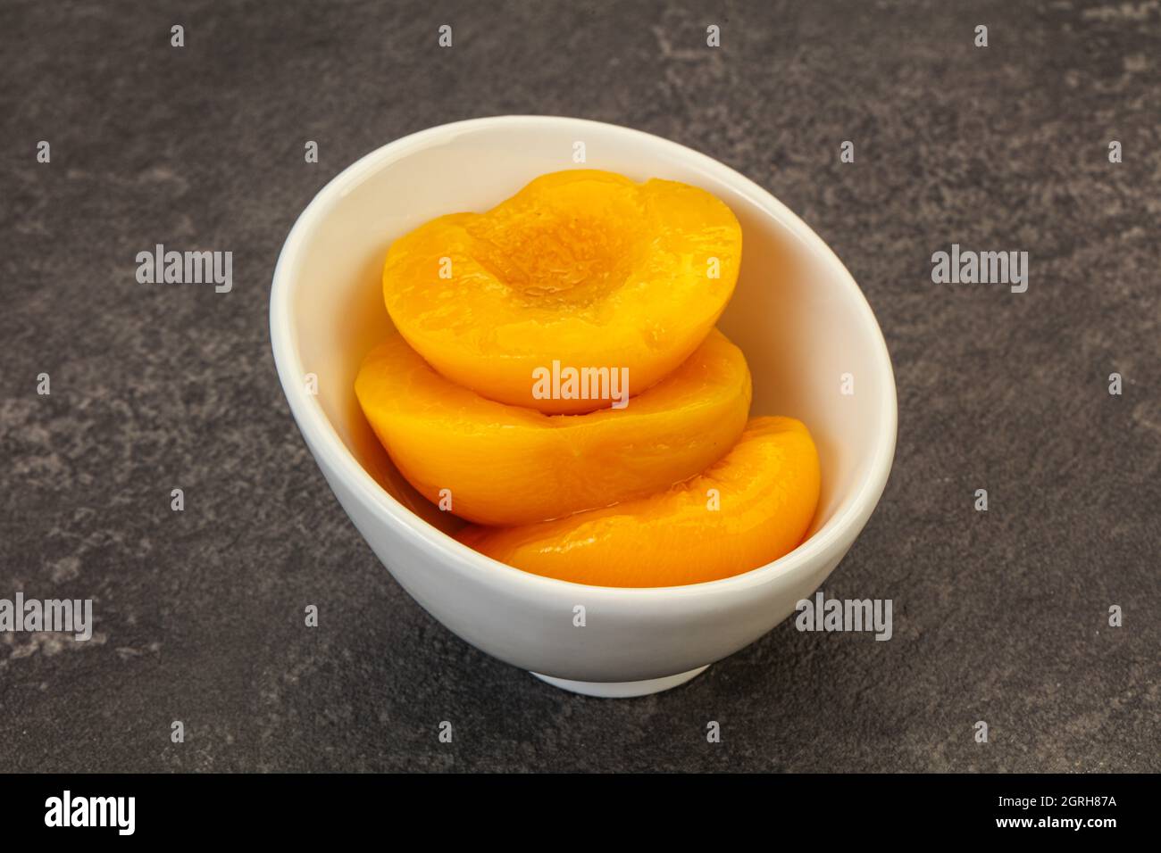 Marinated peaches fruit in the bowl with syrope Stock Photo - Alamy