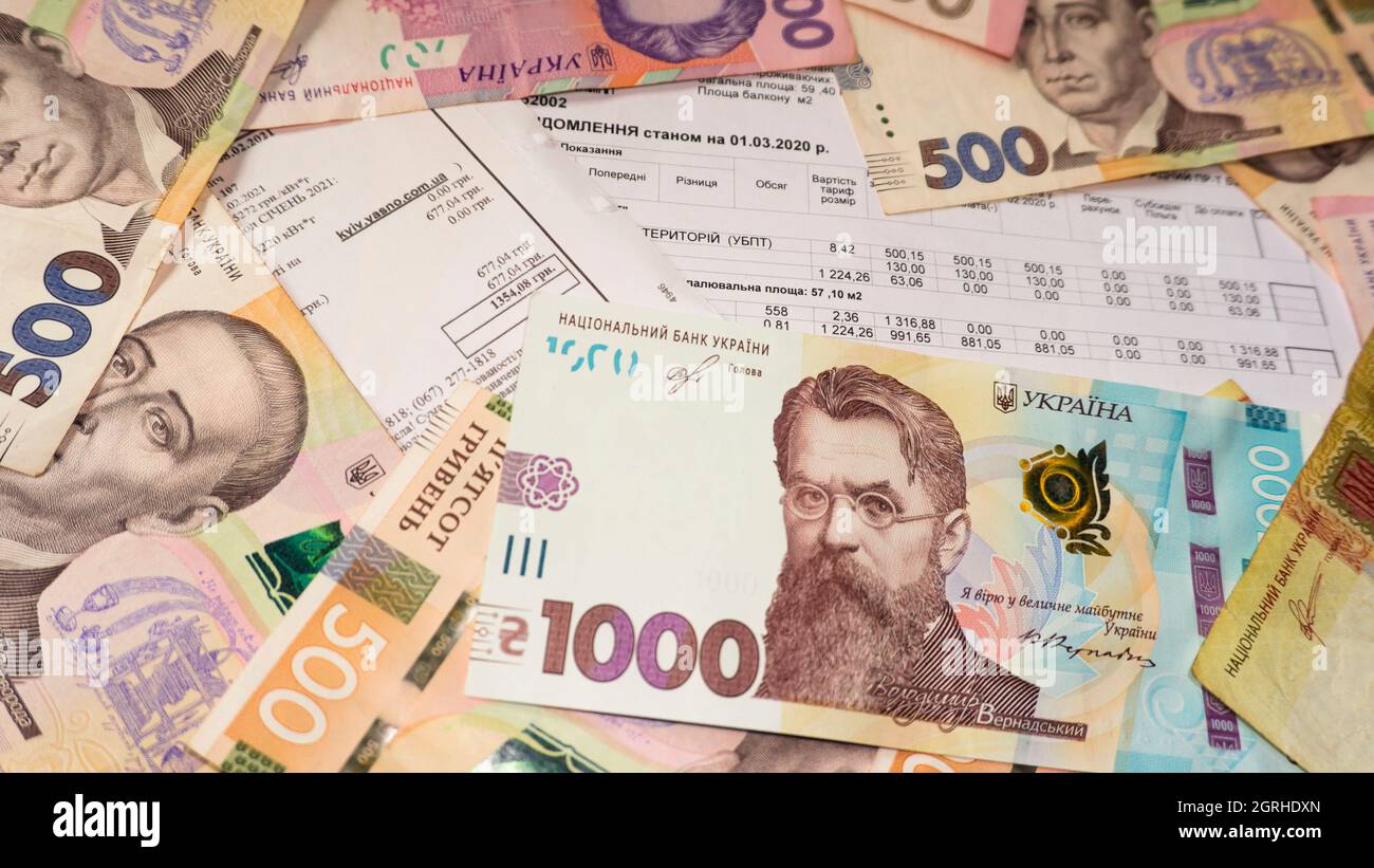 Ukrainian money hryvnia and coins penny wooden background, utility bill ...