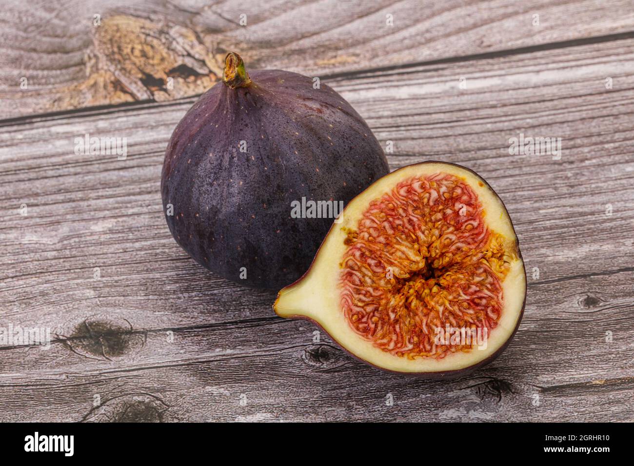 Sweet purple slice of fig fruit Stock Photo - Alamy